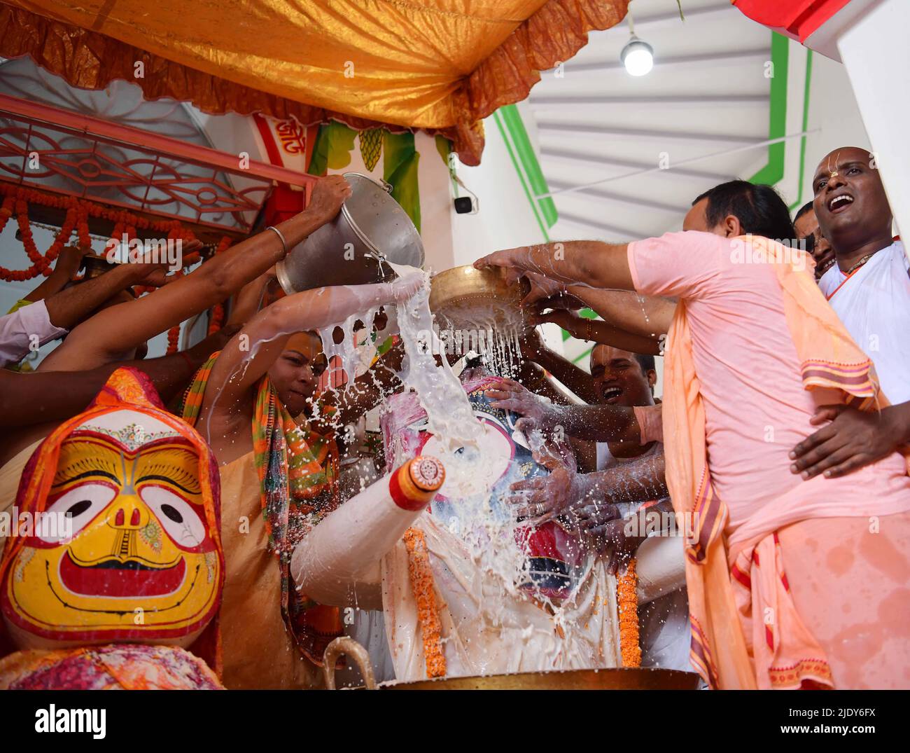 Hindu priests pour milk on top of deities Lord Jagannath, Balabhadra ...