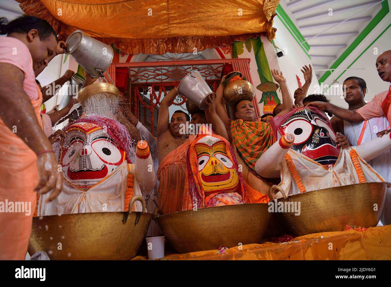Hindu priests pour milk on top of deities Lord Jagannath, Balabhadra ...
