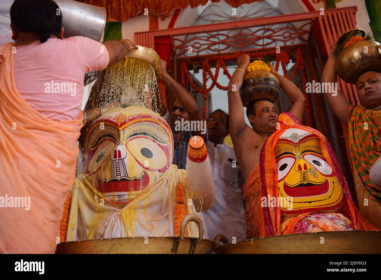 Hindu priests pour milk on top of deities Lord Jagannath, Balabhadra ...