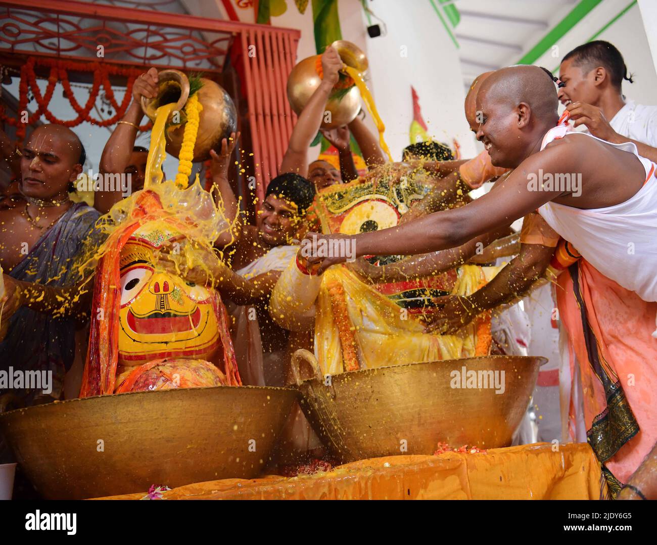 Hindu priests pour milk on top of deities Lord Jagannath, Balabhadra ...