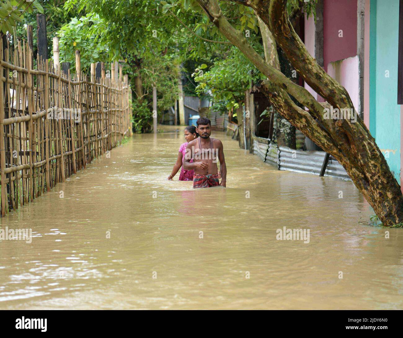 People wade through flood water as they look for shelter amidst heavy ...