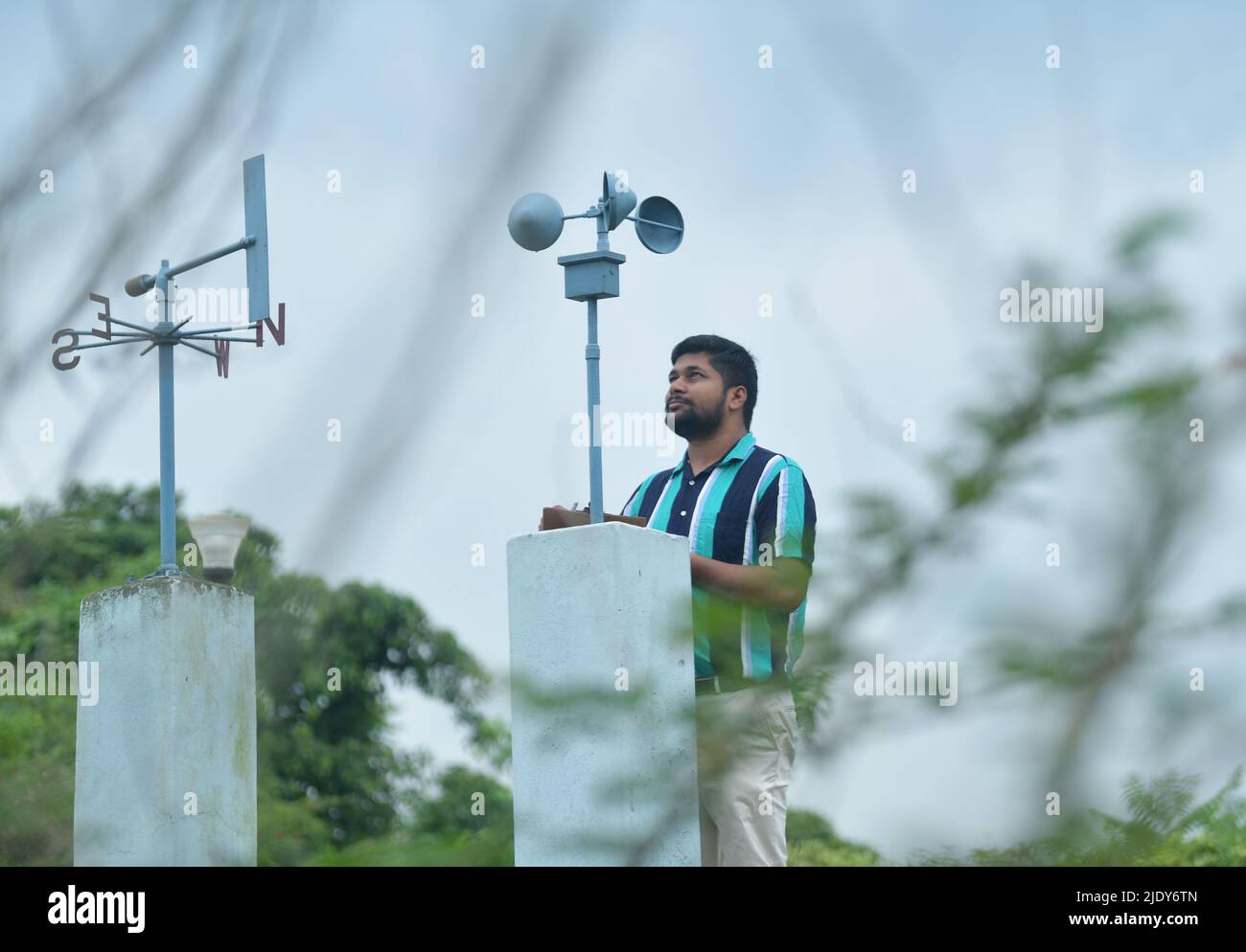 An official of the Meteorological Department of India takes the reading ...