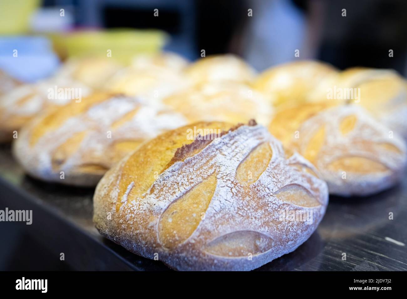 A finished batch of artisan wheat bread, just out of the oven. Front ...