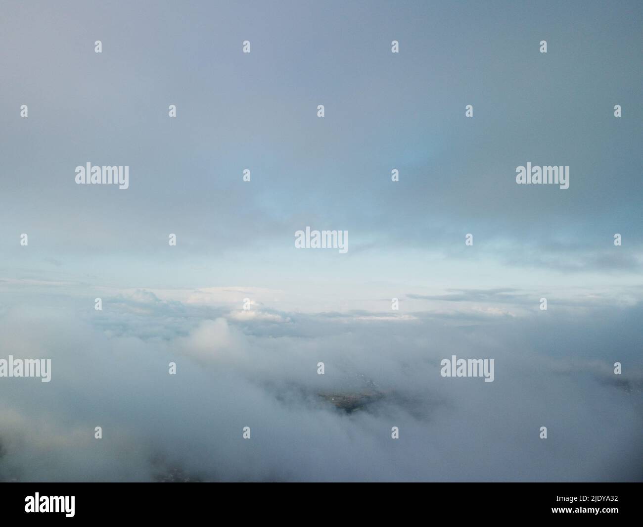 Aerial view. Blue sky sun and fog over calm sea. The drone flies over ...