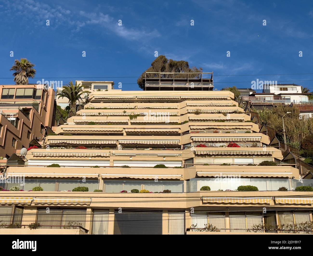 Front view of stepped apartment building on hillside in Reñaca coast ...