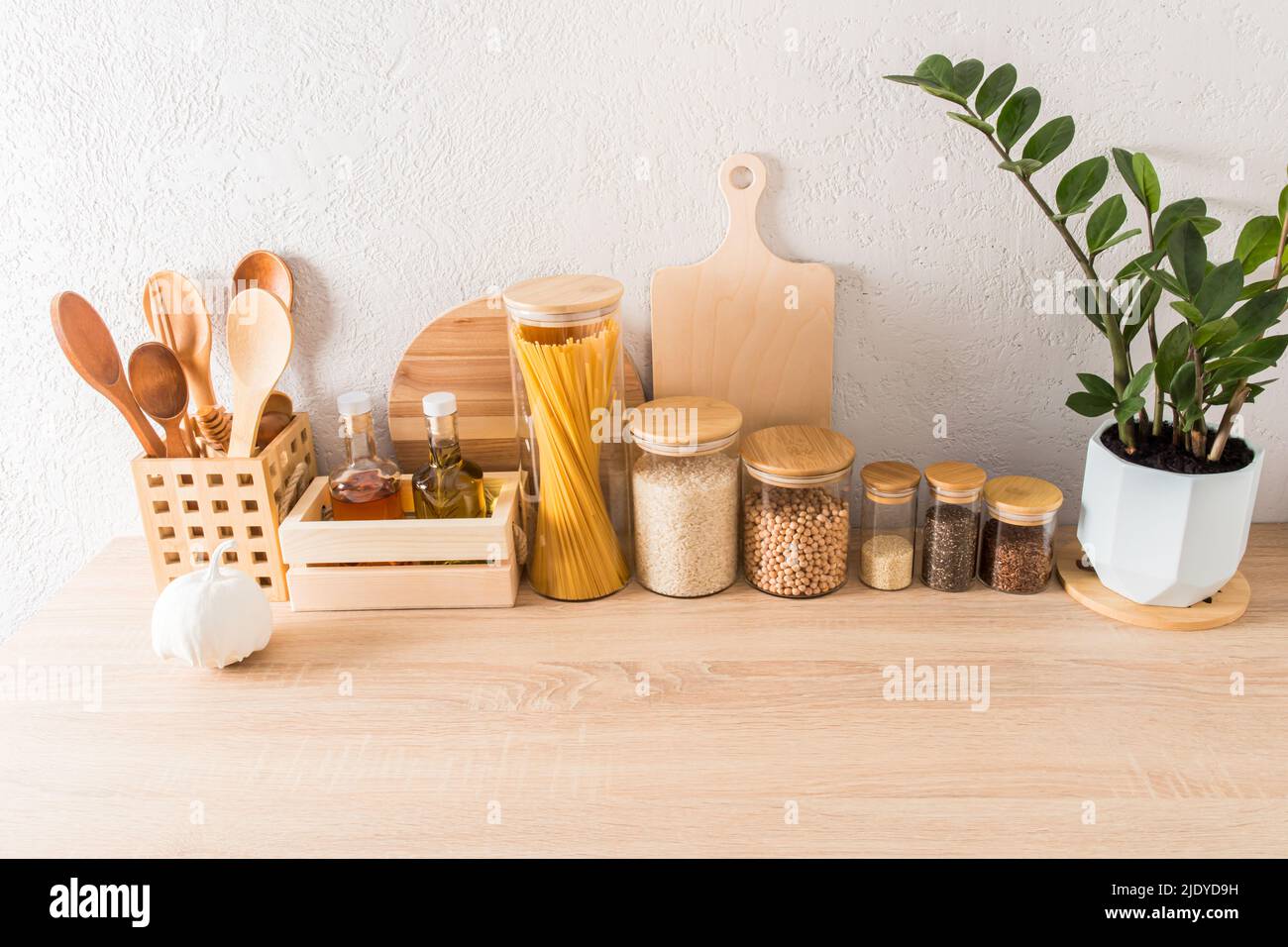stylish white kitchen background with kitchen utensils on a wooden ...