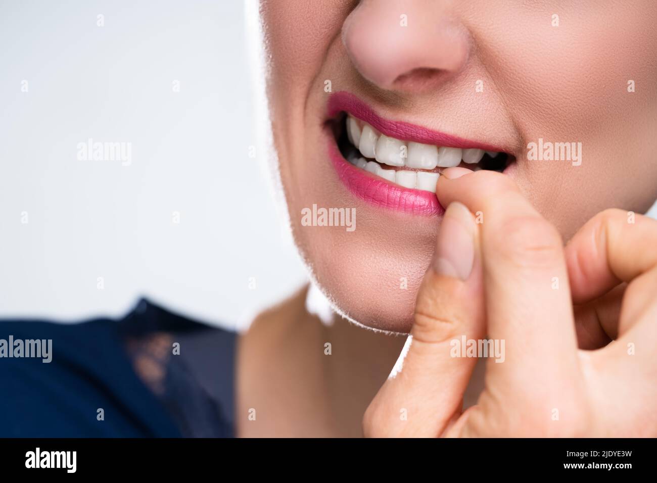 Close-up Of A Businesswoman Biting Her Fingernail Stock Photo - Alamy