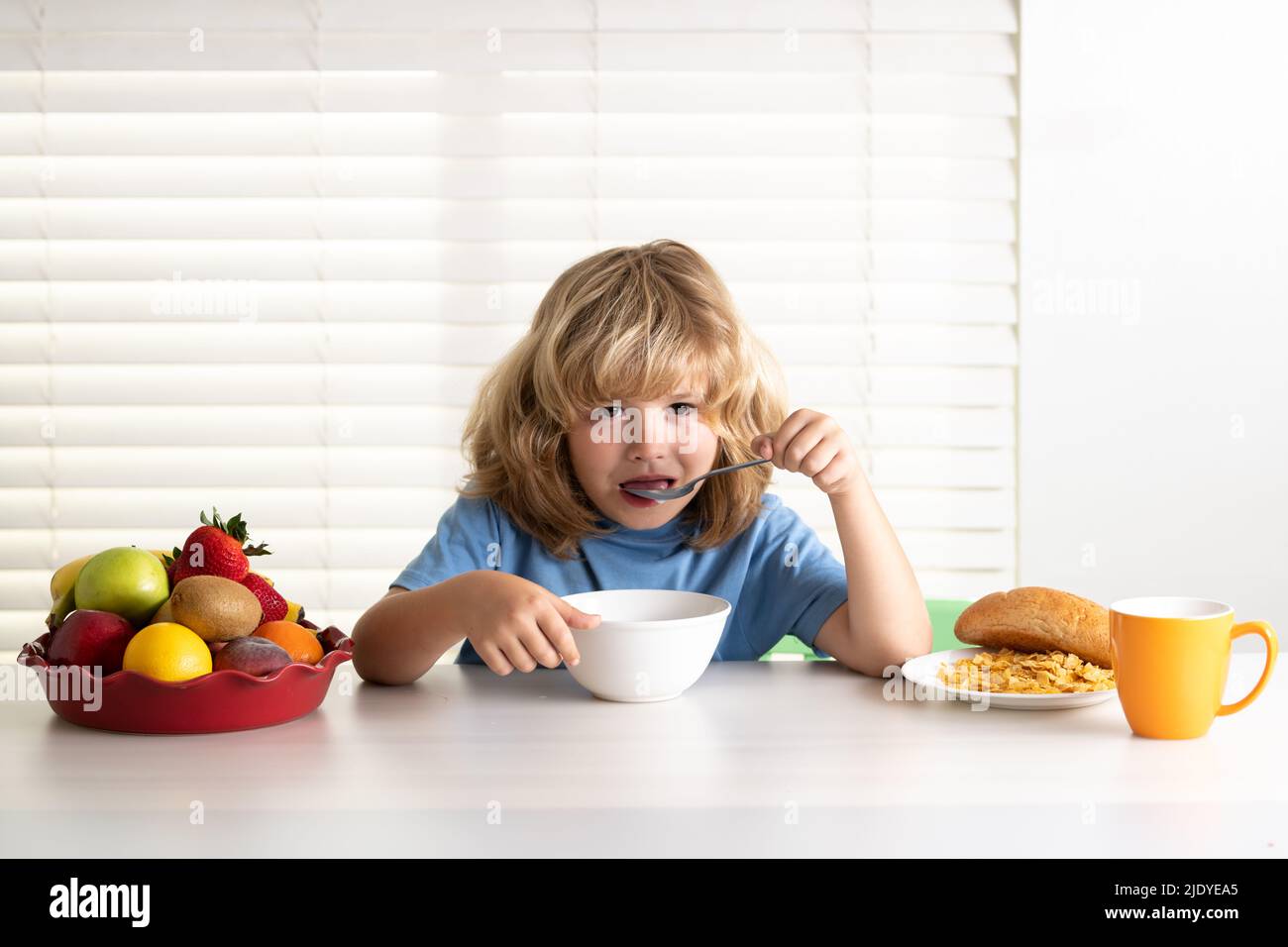Little child boy having healthy breakfast. Kids nutrition and ...