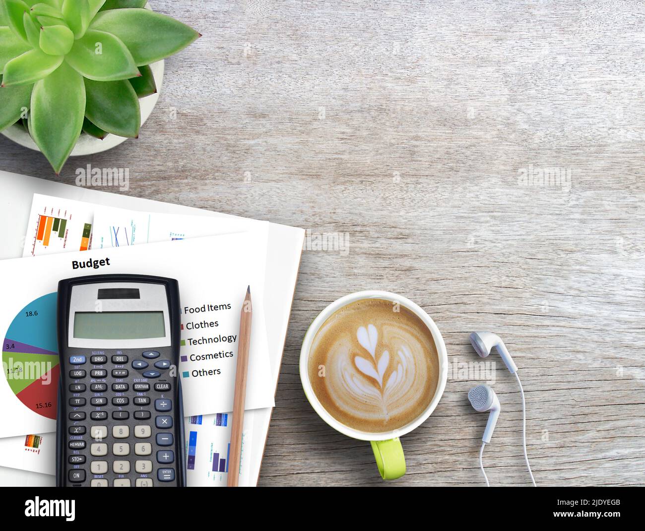 Financial chart,calculator,earphone and cup of coffee with flower on ...