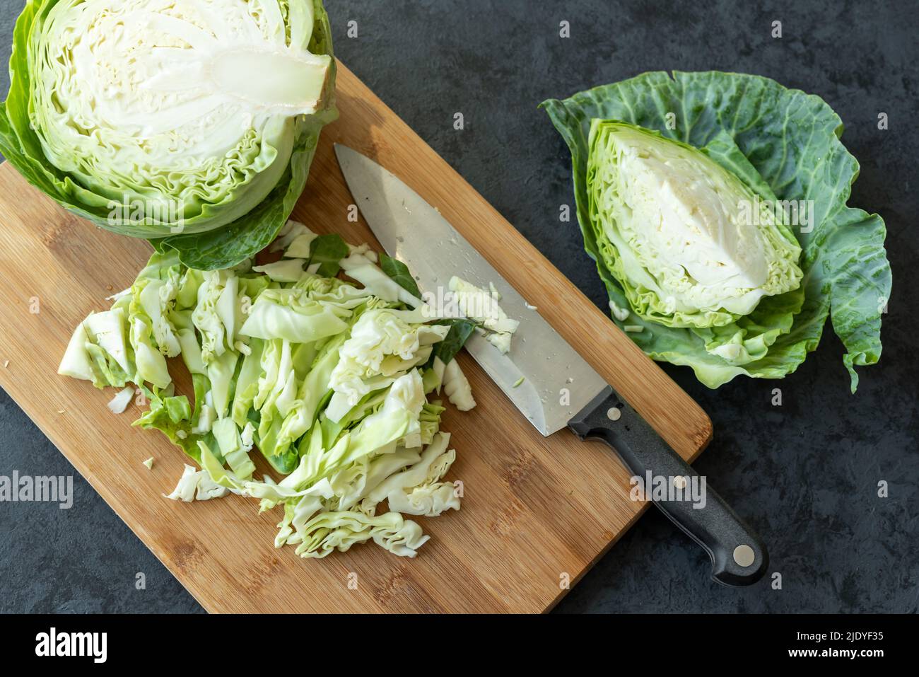 Chopped young fresh cabbage on a kitchen board Stock Photo - Alamy