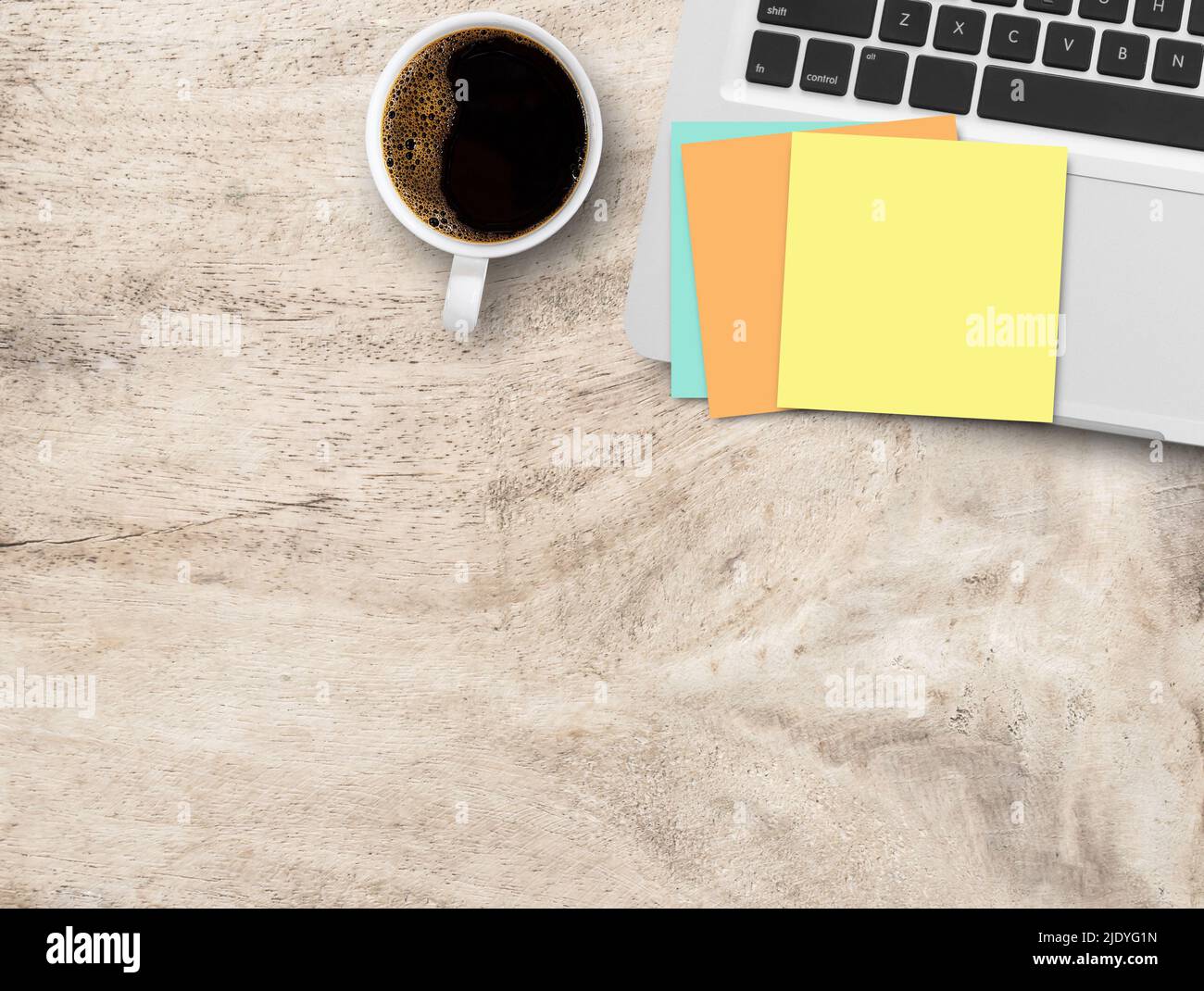 Office desk with sticky note,laptop computer,pen and cup of coffee on ...