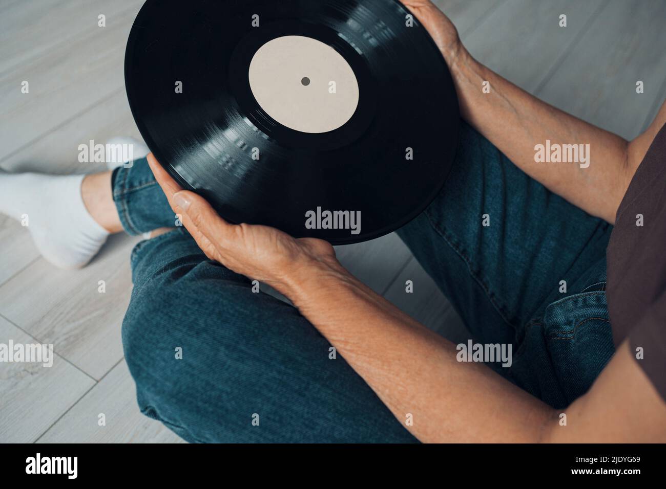Woman holding a vinyl record . side view Stock Photo - Alamy