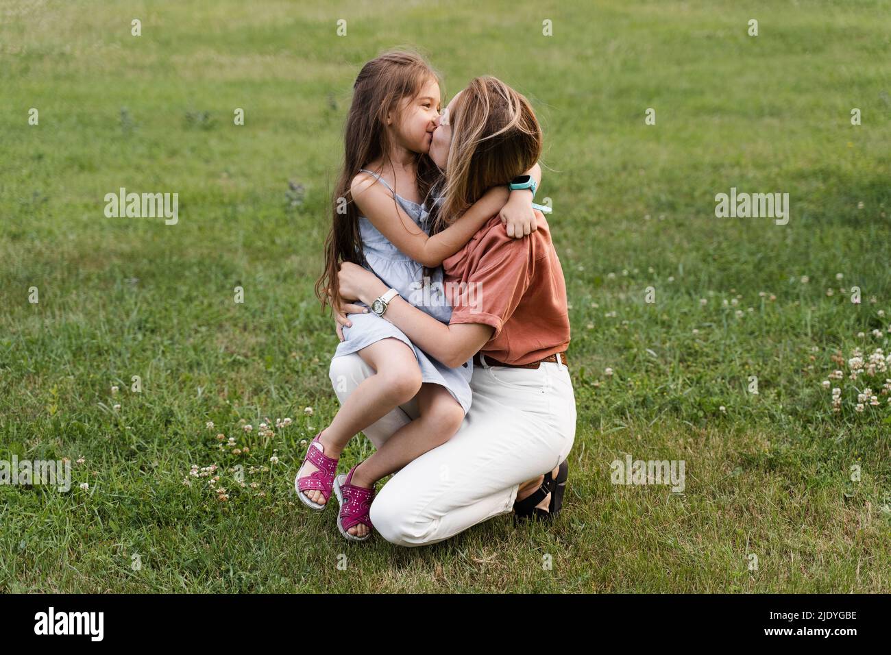 Mom and daughter embrace and smile. Family values. Happy family lifestyle. Happiness and joy of ...