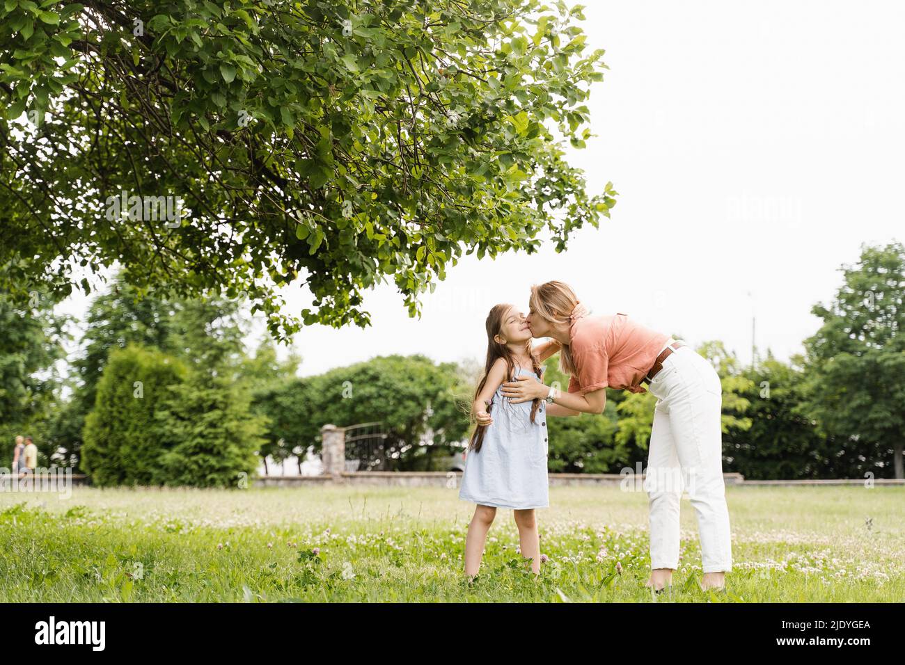Mother kissing and hug her daughter. Hapiness emotion. Family values. Happy family lifestyle ...