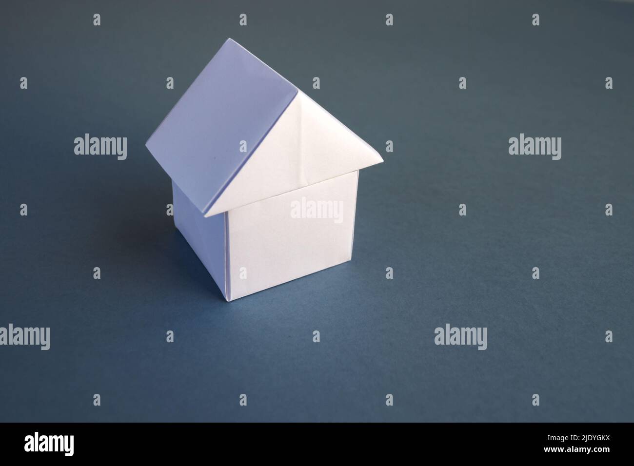 White paper house origami isolated on a blank grey background Stock ...