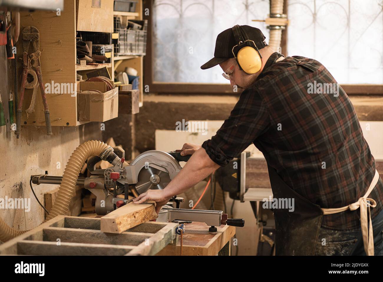 Joiner worker, businessman in protective apron and headphones use ...