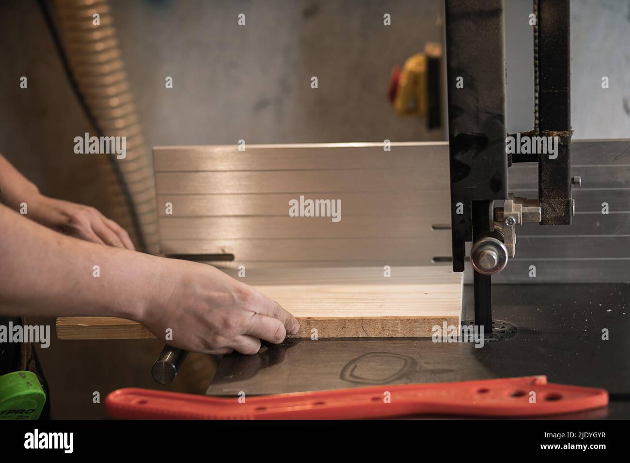 Unrecognizable joiner, professional man hands using panel sizing saw ...