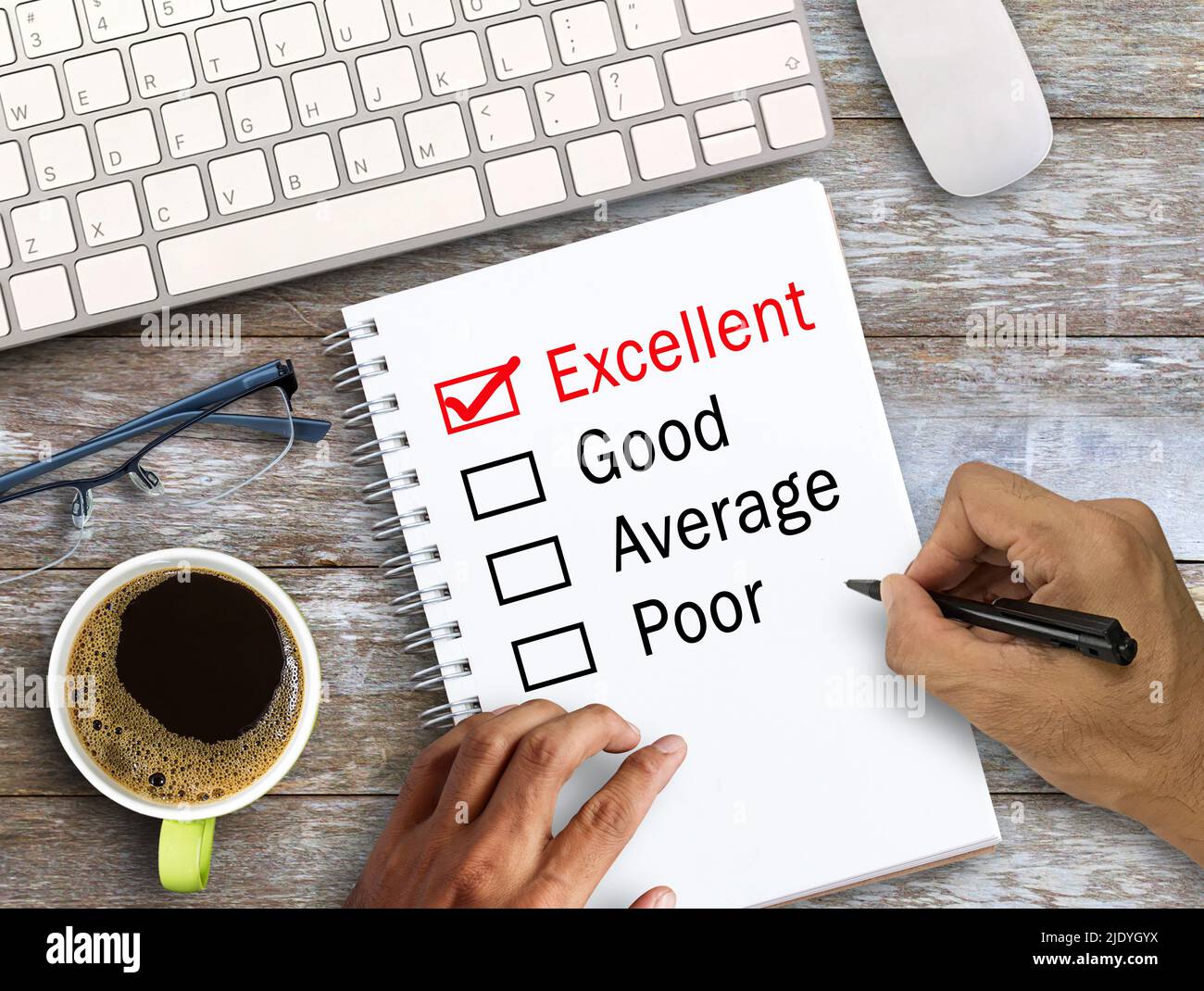 Top view with handwriting Excellent,Good,Average,Poor on notebook ...