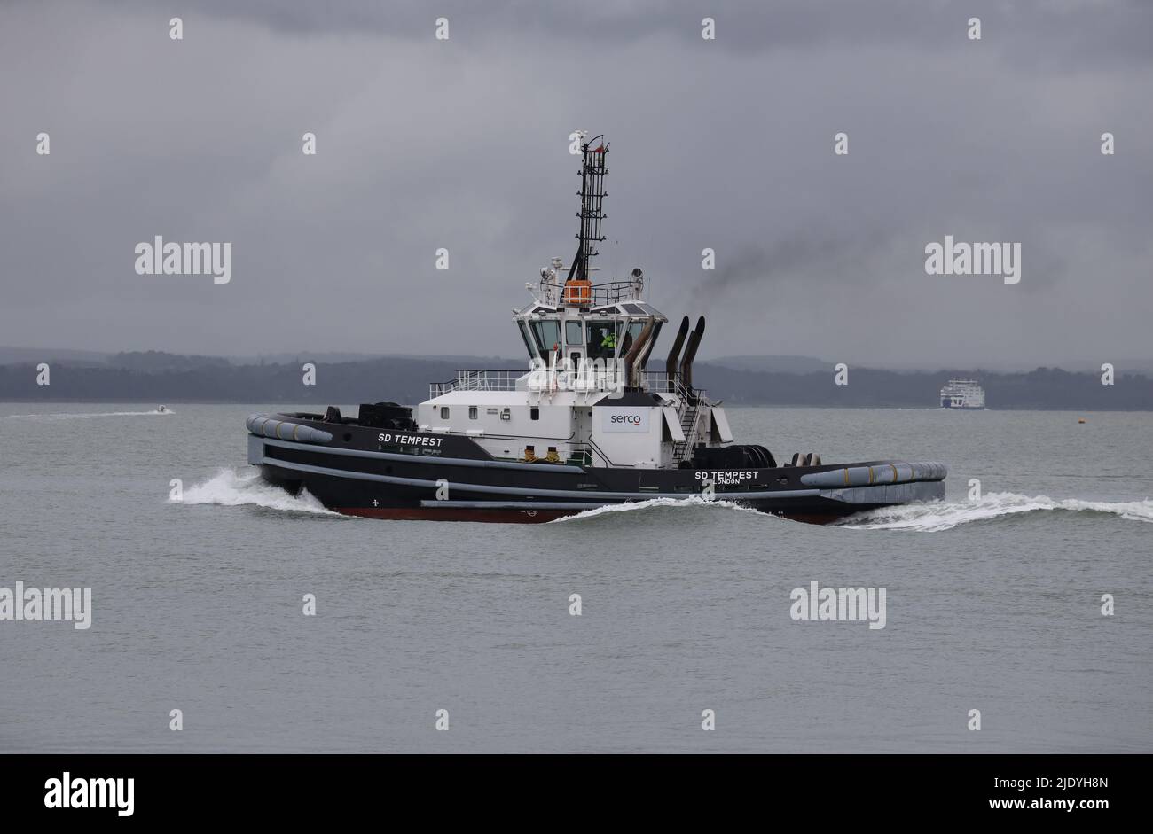 The Serco Denholm tug TEMPEST crossing The Solent under a grey sky ...