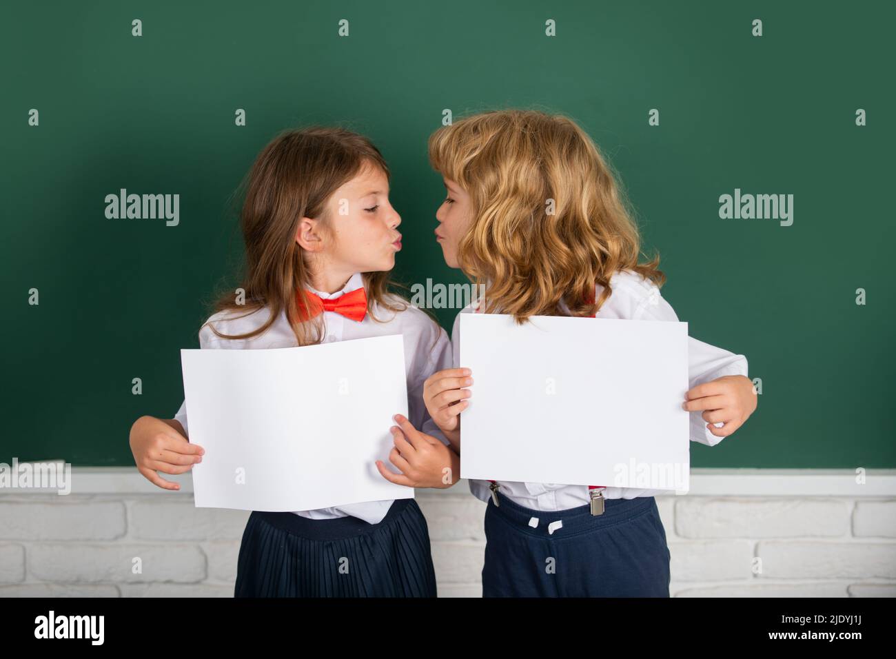 Kids love, first kiss. Back to school. Schoolchild friends back to ...