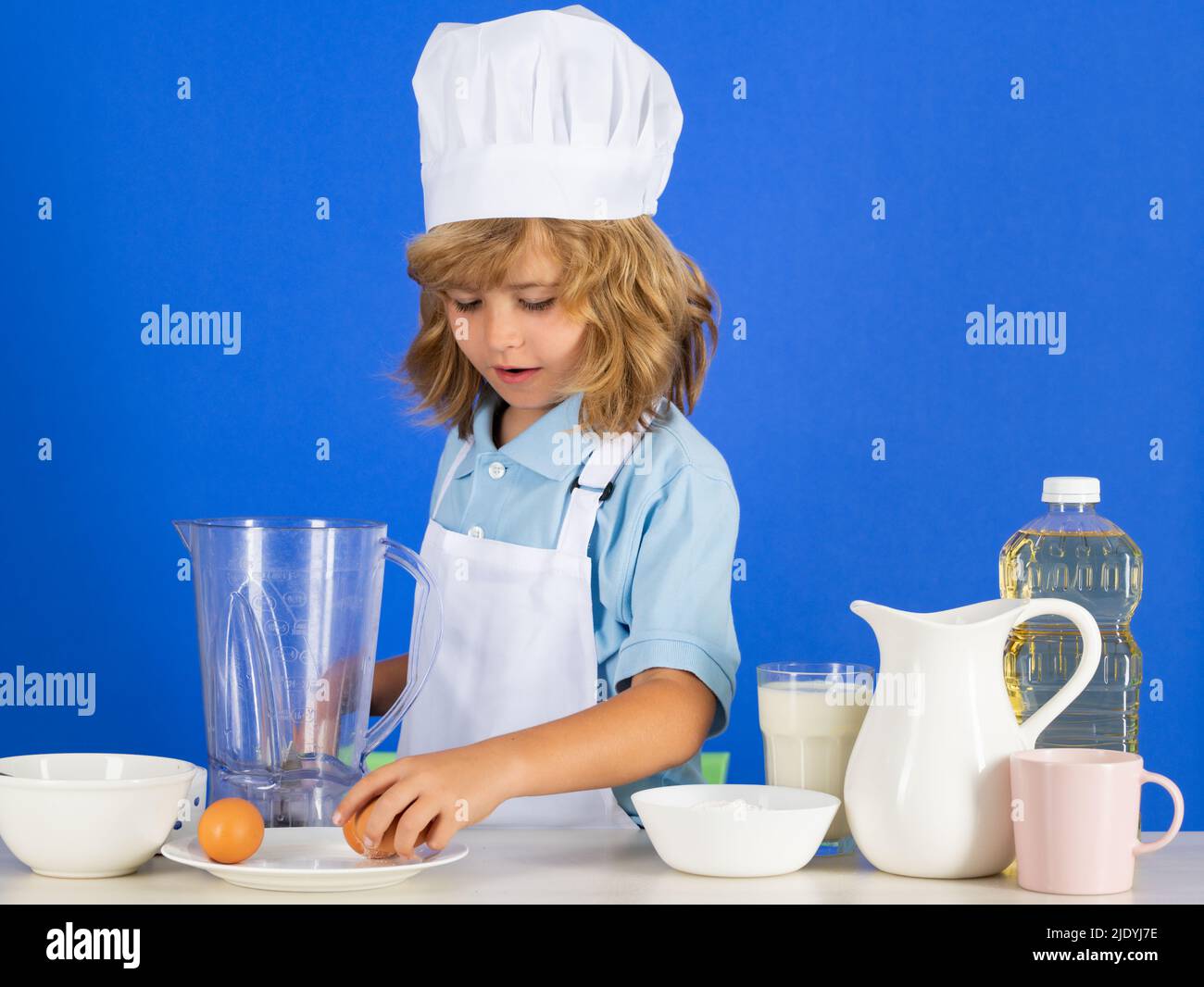 Portrait of chef child in cook hat. Cooking at home, kid boy preparing ...