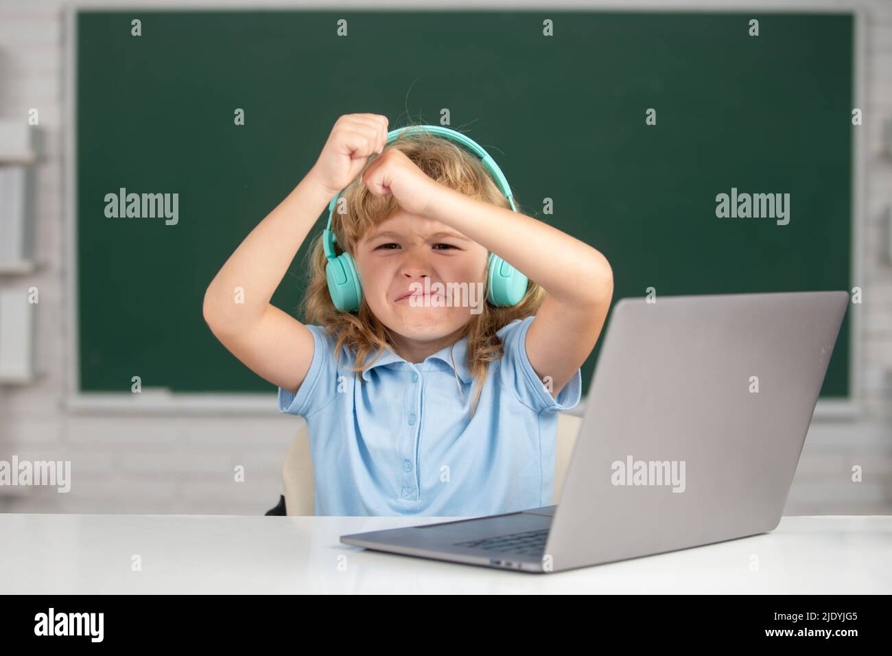 Angry child using laptop computer, sad excited kid boy studying through ...