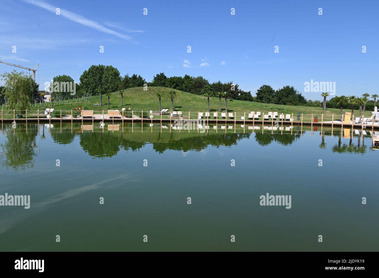Euskirchen, Germany. 22nd June, 2022. A lake with deck chairs stand on ...