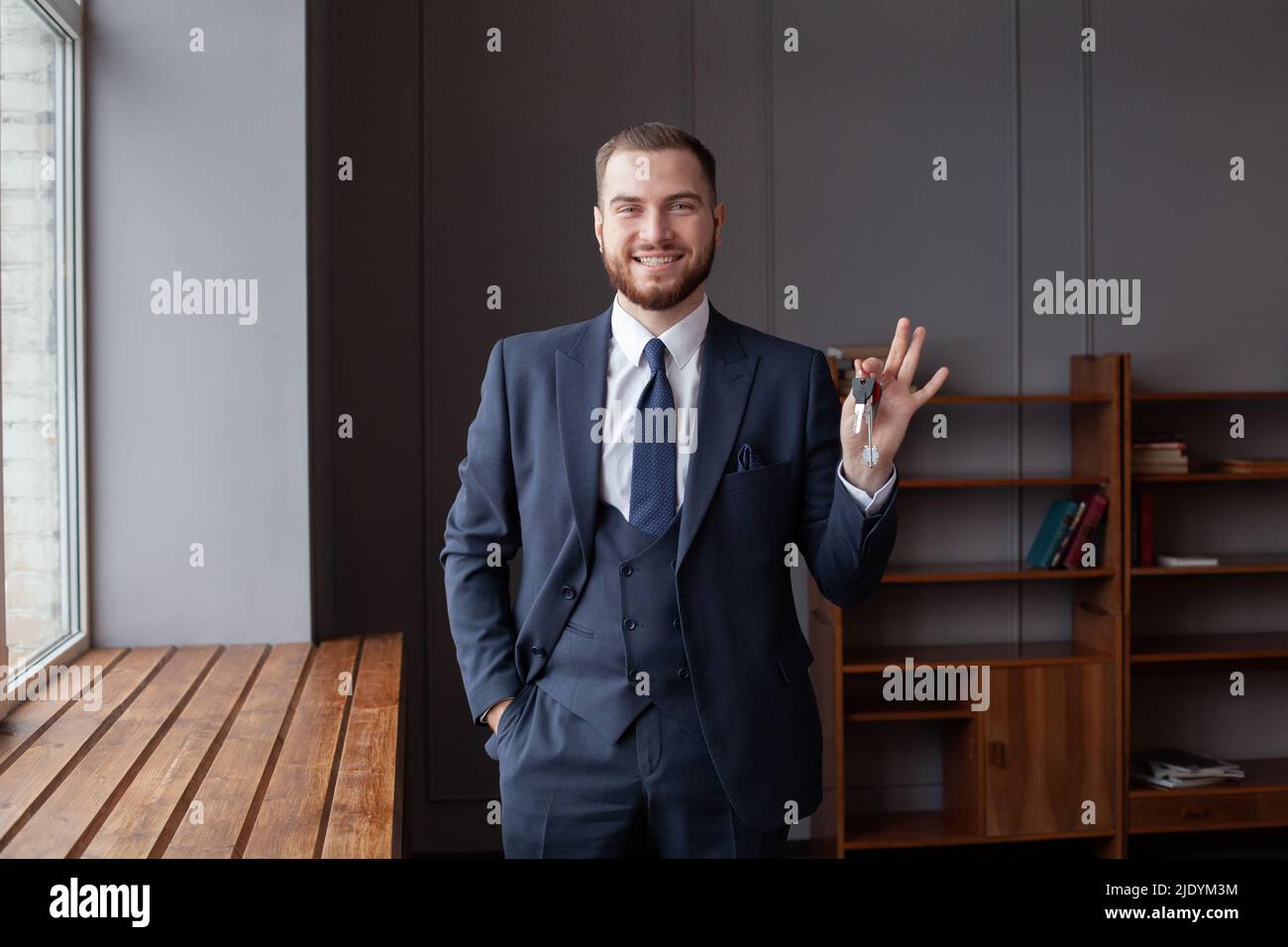 Happy homeowner portrait. Glad proud guy hold get show keys from rented ...
