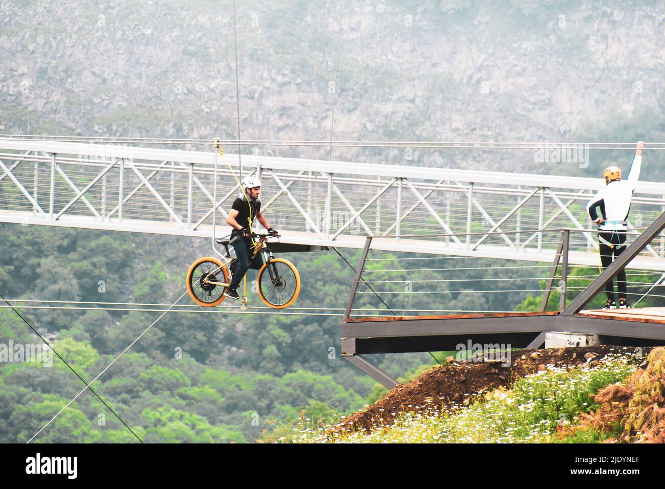 Dashbashi, Georgia- 19th JUne, 2022: male man ride zip bike over valley in beautiful caucasus ...