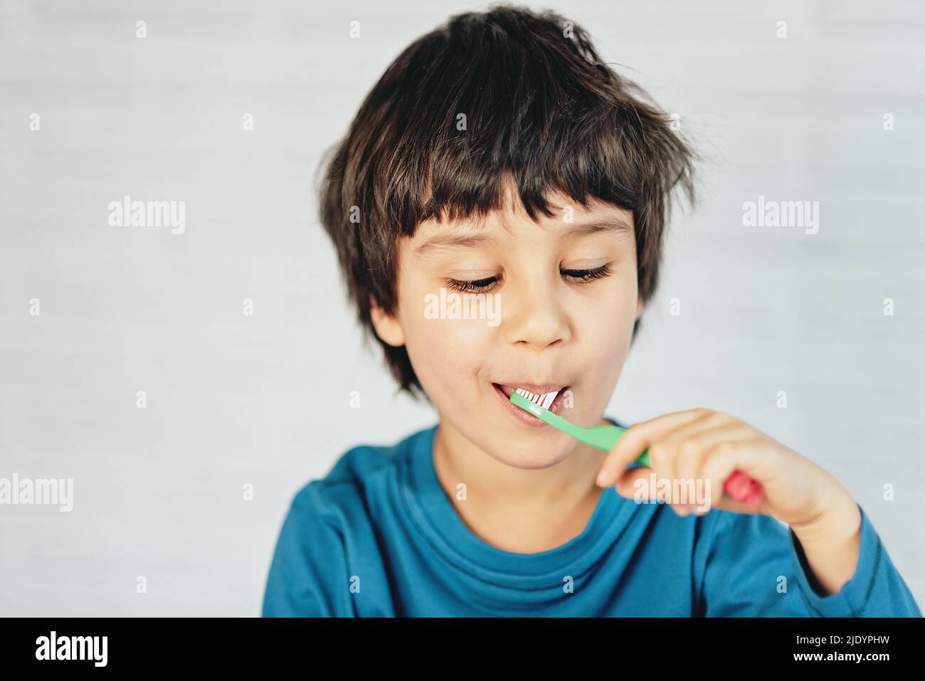 Little boy brushing his teeth on white background. little kid cleans ...