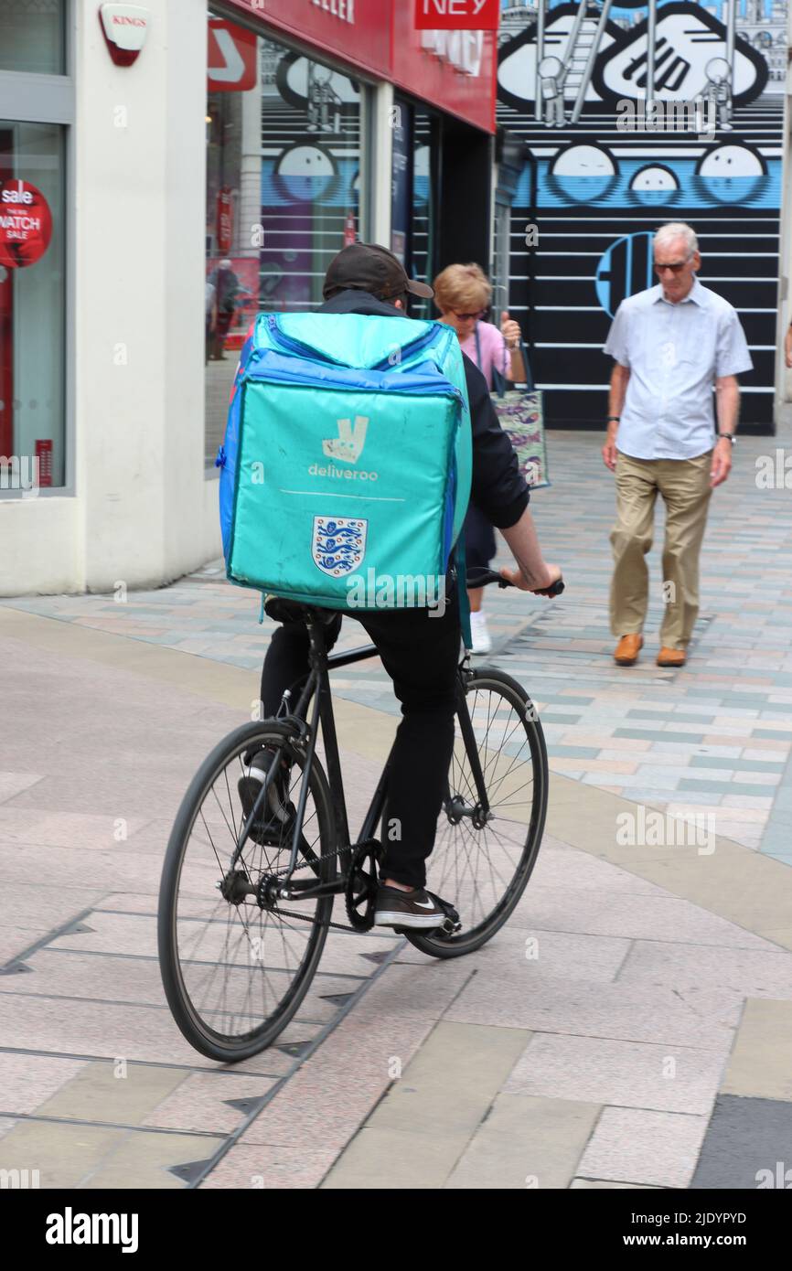 Deliveroo cyclist riding along High Street, Chelmsford, Essex, UK Stock ...