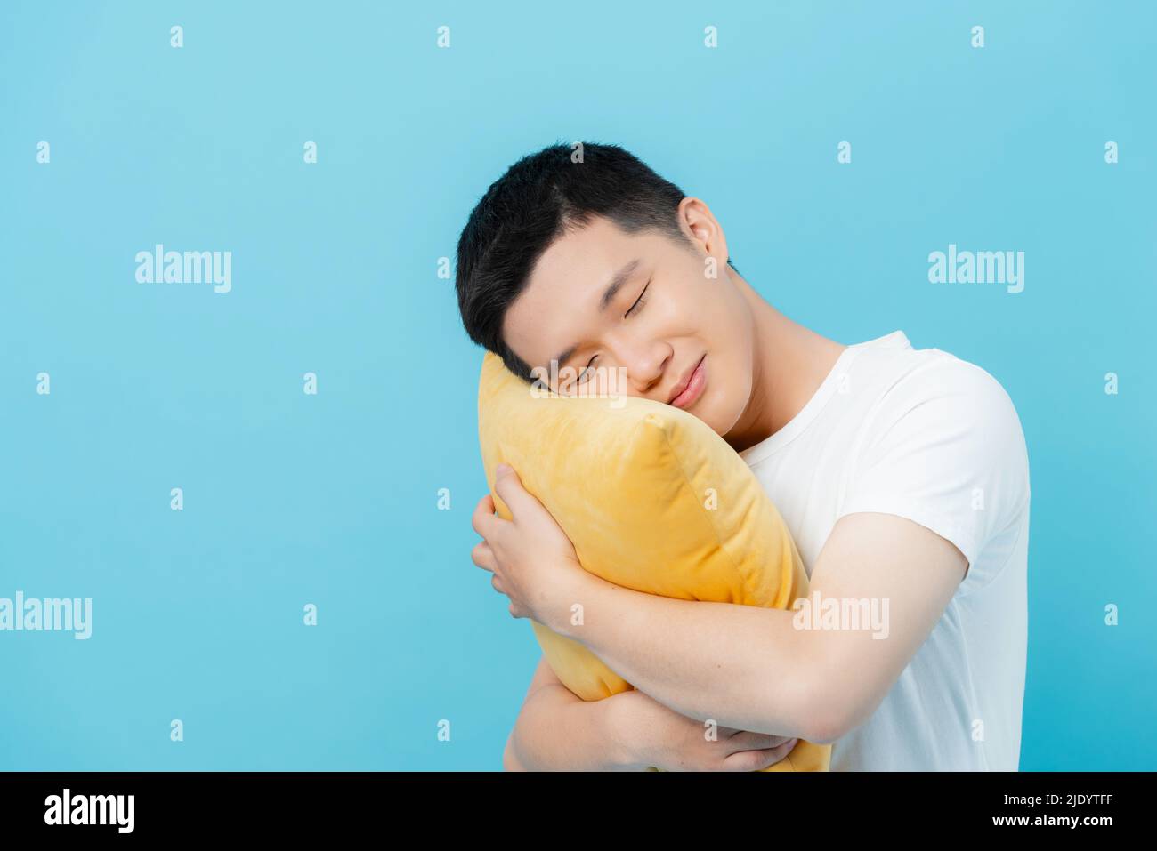 Male hugging a pillow with closed eyes isolated on white background Stock Photo - Alamy