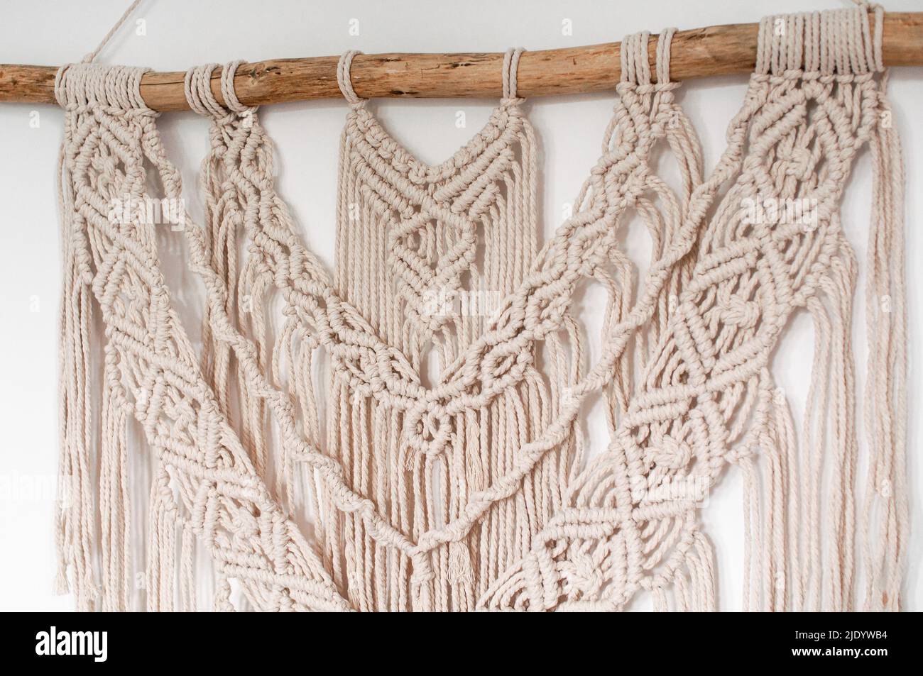 Wall decor in the style of weaving macrame handmade from beige natural ...