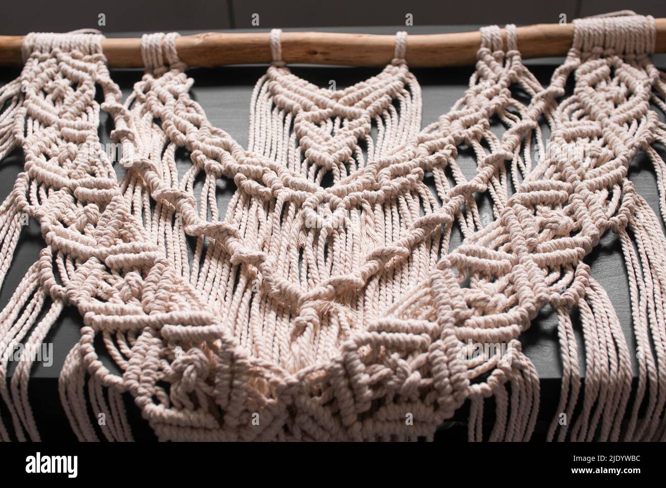 Part of the decor in the style of weaving macrame handmade from beige ...