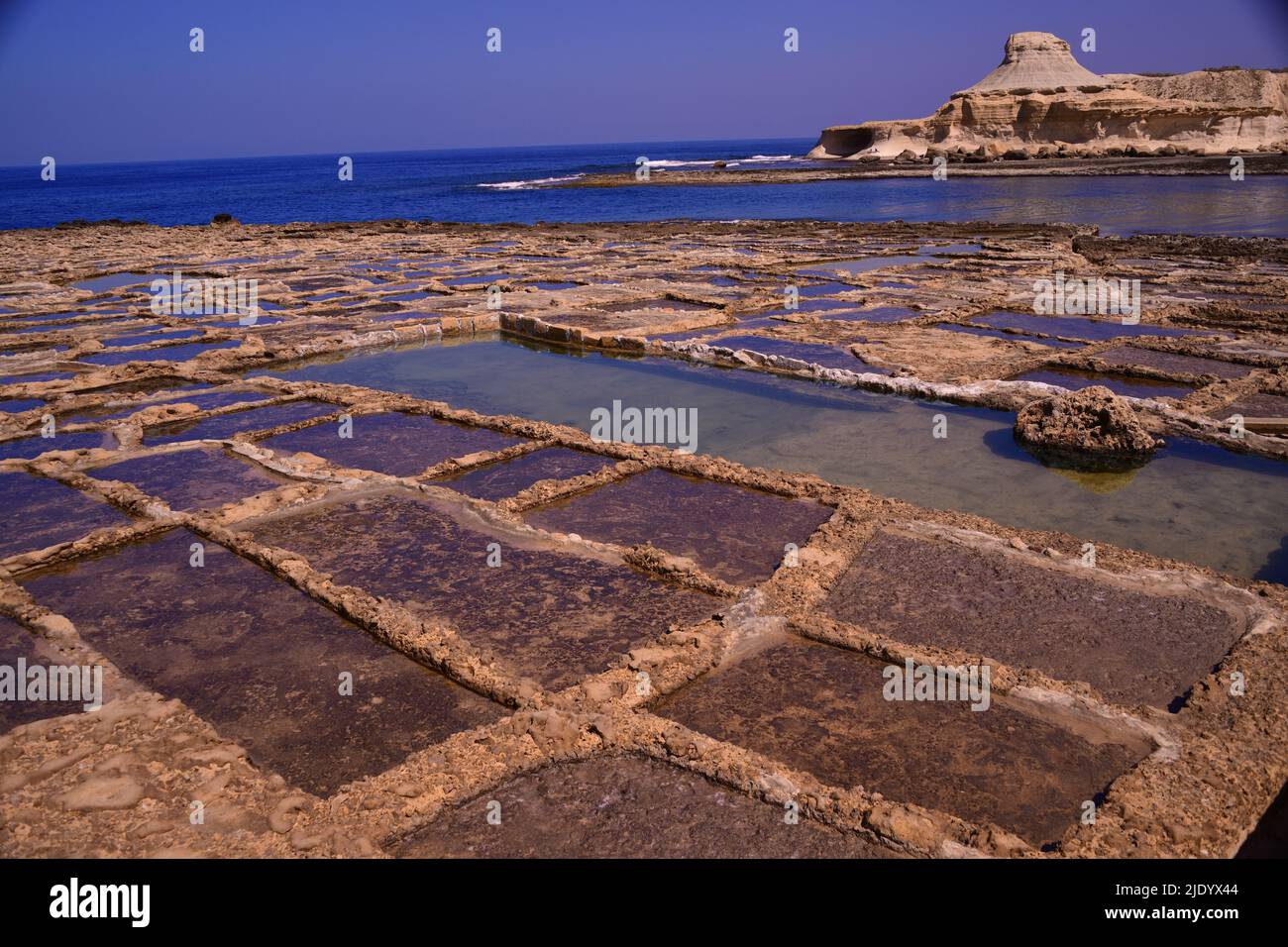 Traditional salt pans cut into the rock on the coast of Gozo, Malta ...