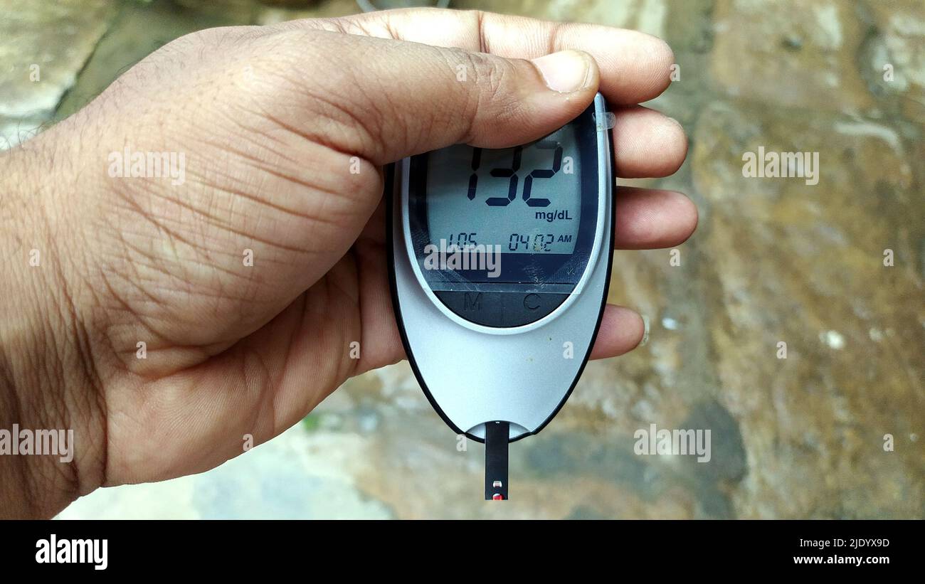 Diabetes machine in hand prick finger to make punctures to obtain small ...