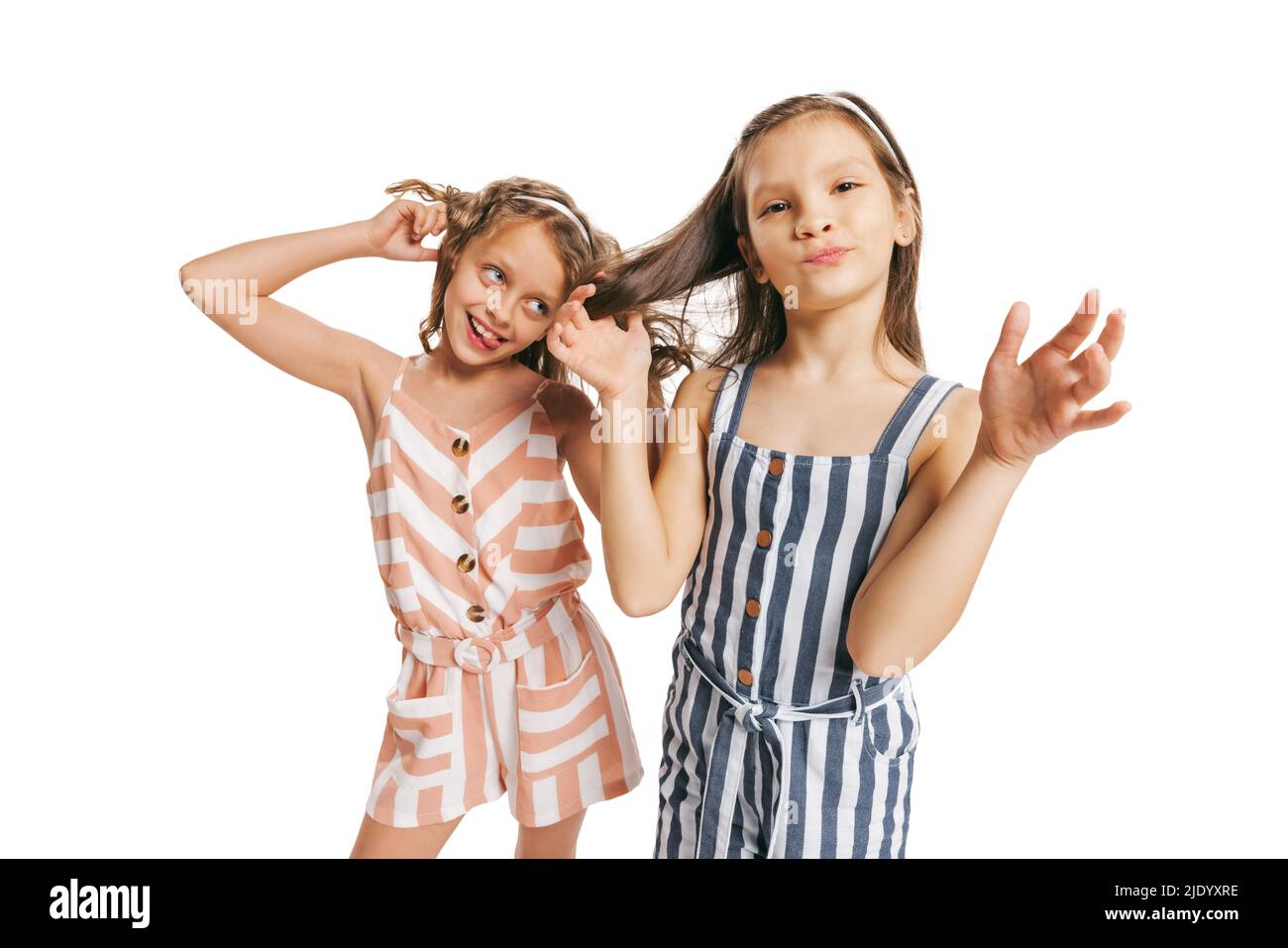 Portrait of two cheerful girls in retro style summer outfit isolated on ... Portrait of two cheerful girls in retro style summer outfit isolated on ...