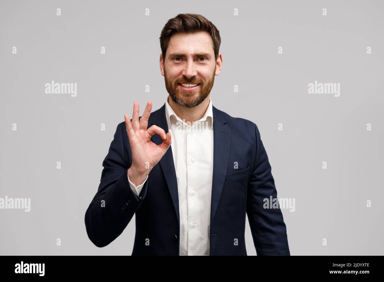 Man in suit showing sign by hand that everything be Okay. Business ...