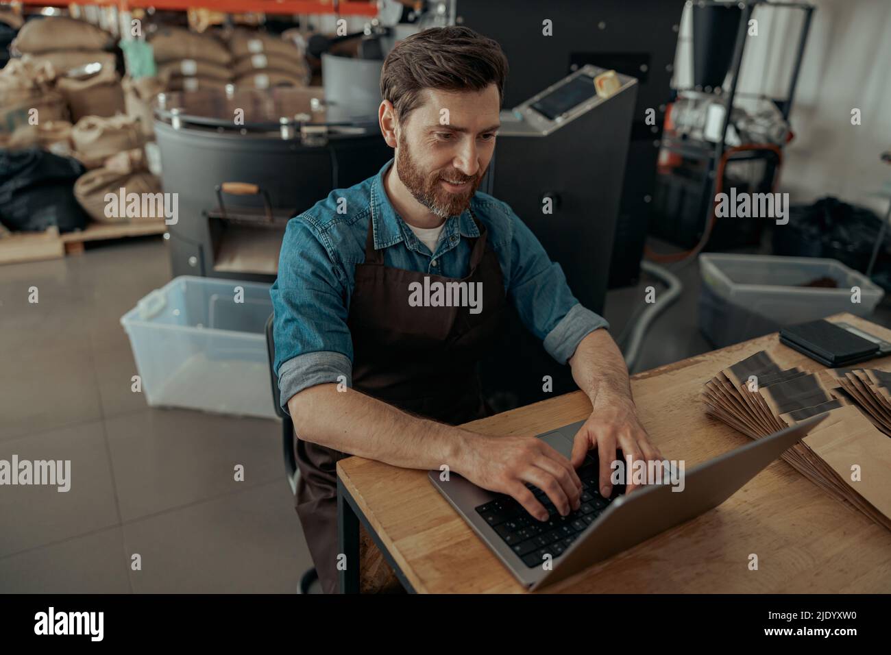Business owner of small coffee roasting factory working on his ...