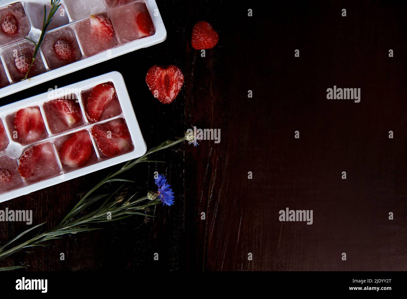 Strawberry ice in the forms. Preparing summer ice for cocktail, ice ...