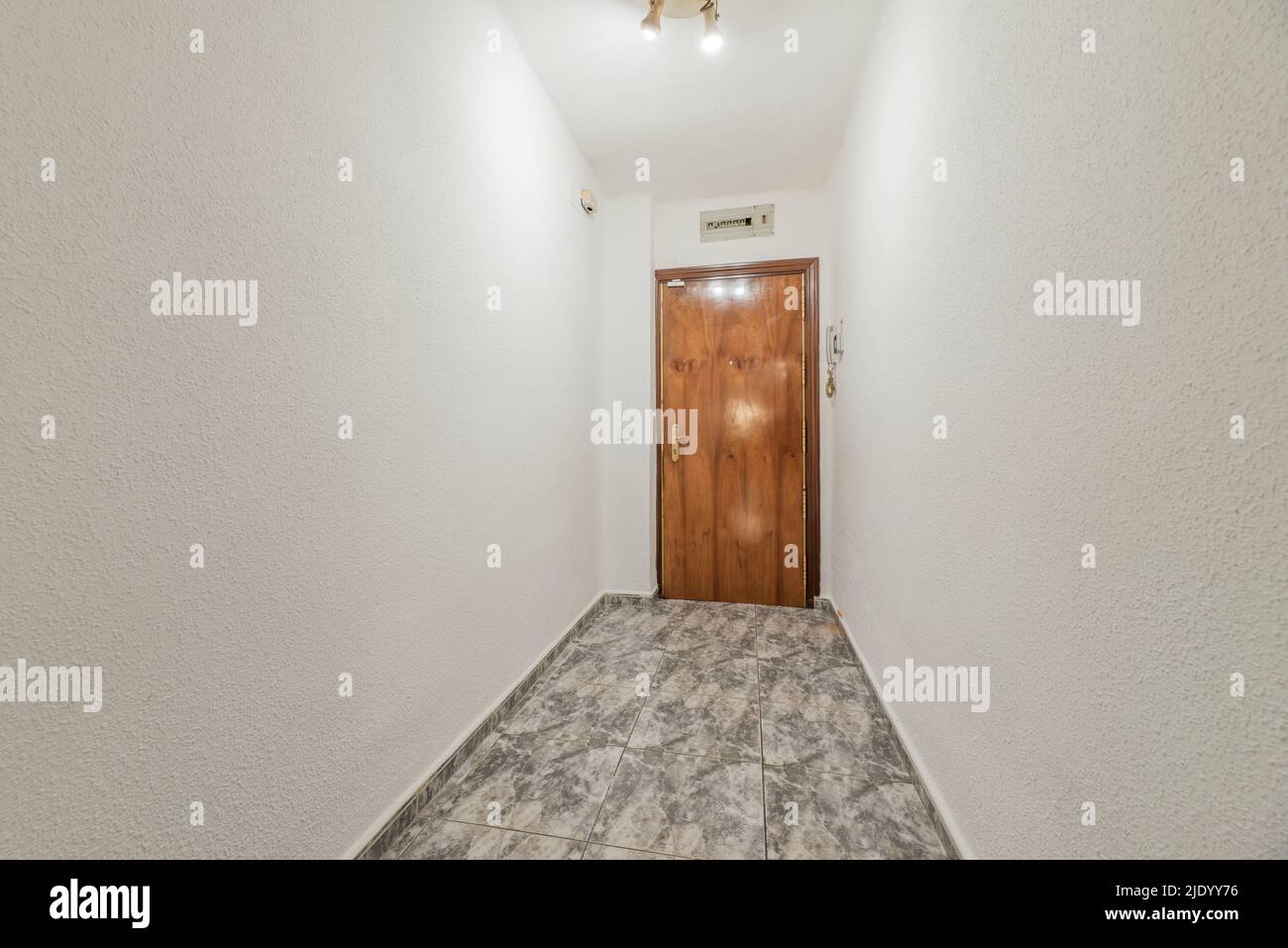 Entrance door to a home with ceramic stoneware floors and walls painted ...