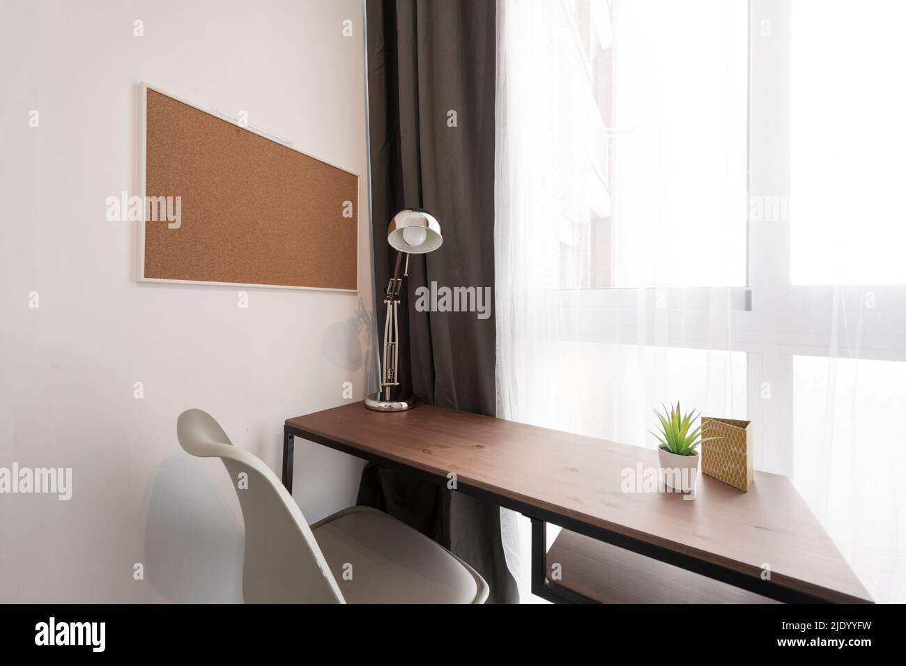 Simple brown wood and black metal study table with resin swivel chair ...