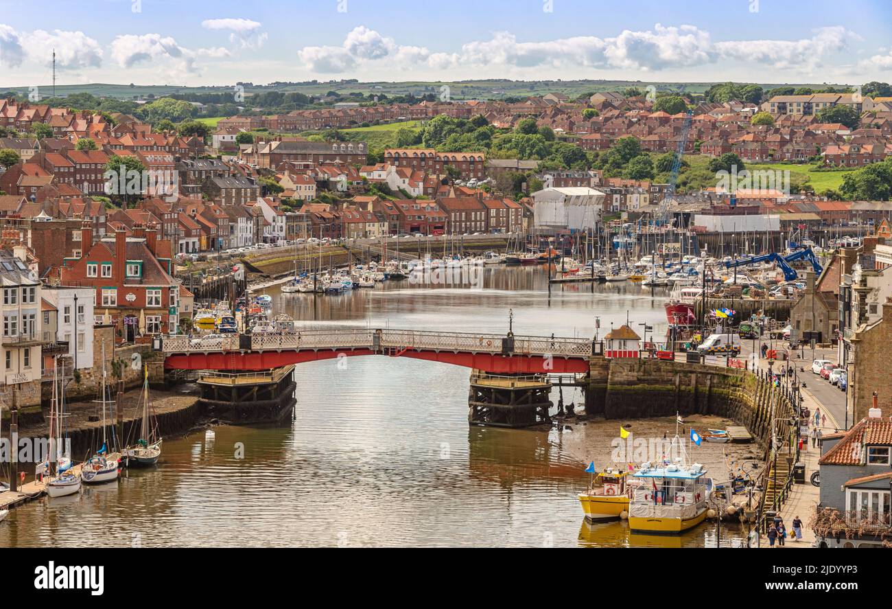 A panoramic view of Whitby harbour. A bridge is prominent and there is ...