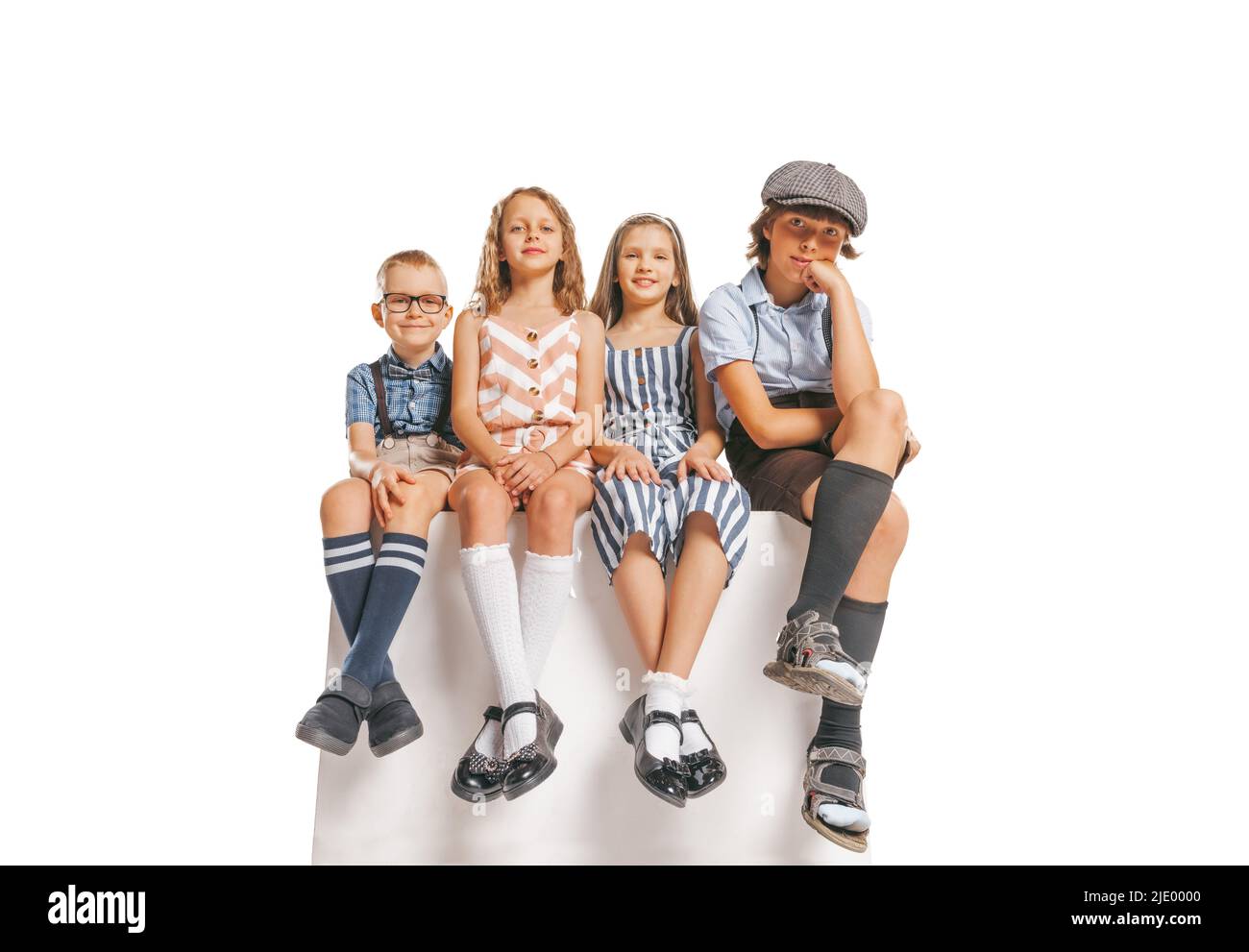 Group of cheerful kids in retro style summer outfit isolated on white ...