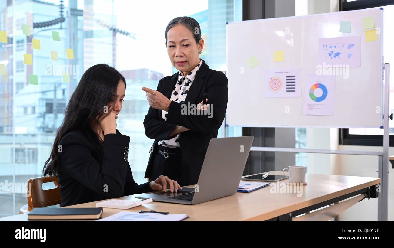 Furious boss scolding young frustrated intern with bad work results ...