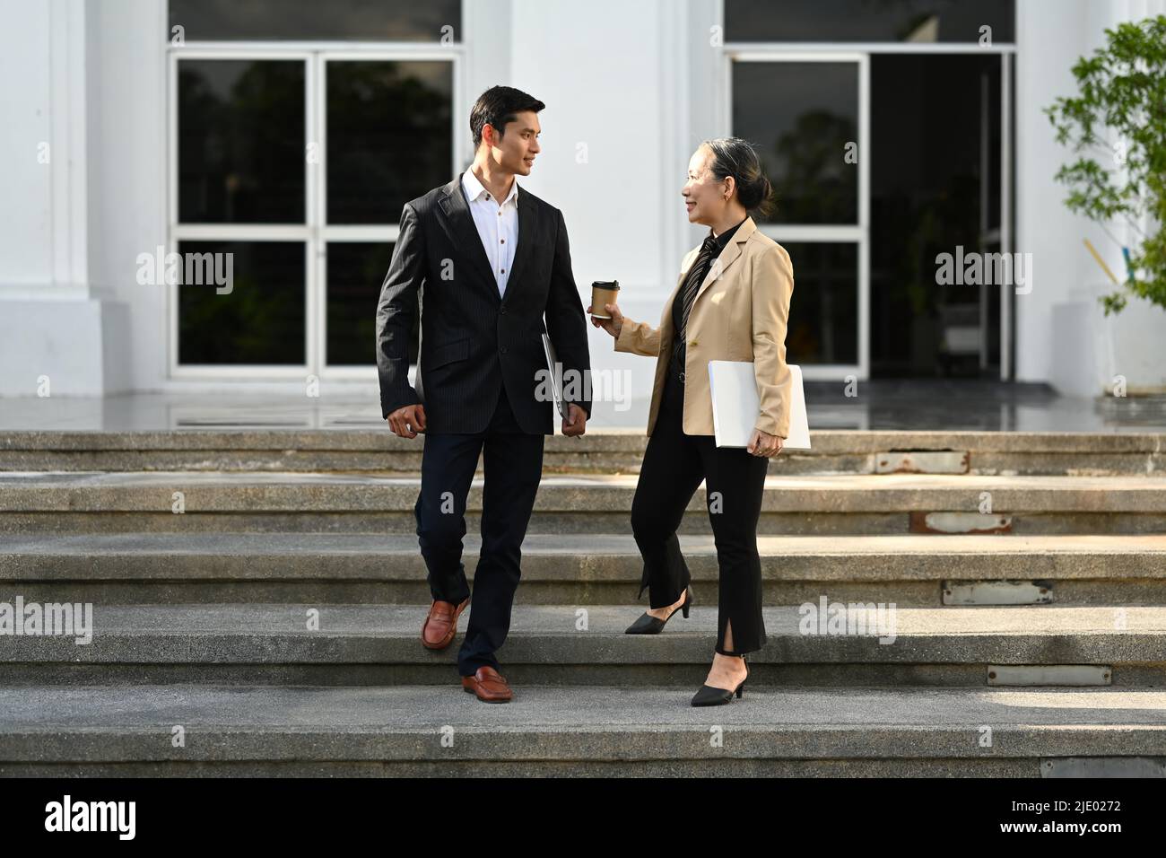 Successful business people having a nice conversation each other and ...