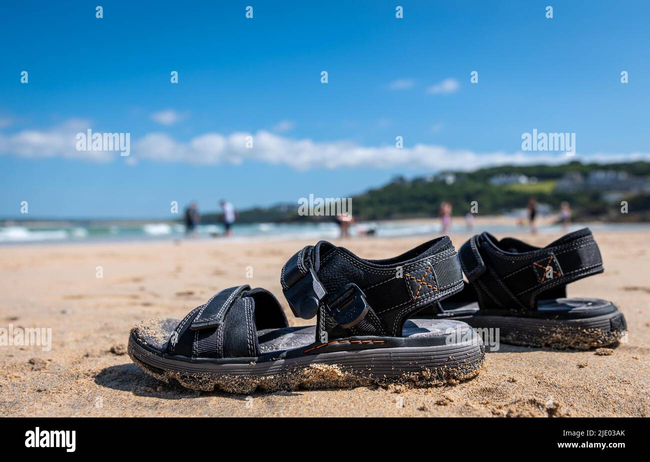 A close up of a pair of sandals on a beach looking out to sea Stock ...