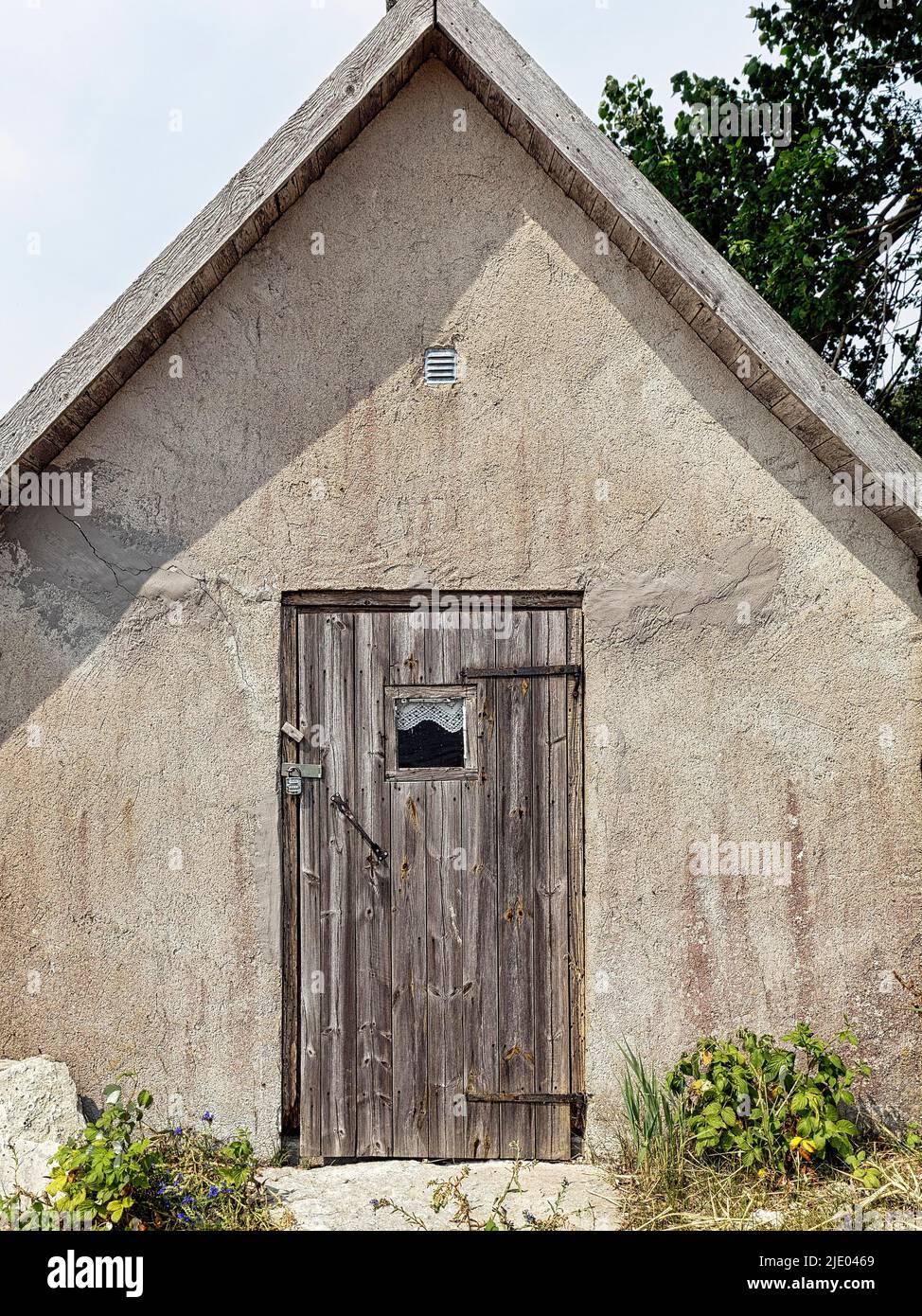 Old stone fisherman's hut with wooden door, fishing spot, seasonally ...