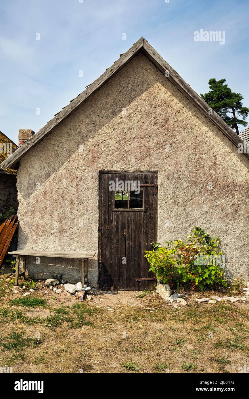 Old stone fisherman's hut with wooden door and bench, fishing spot ...
