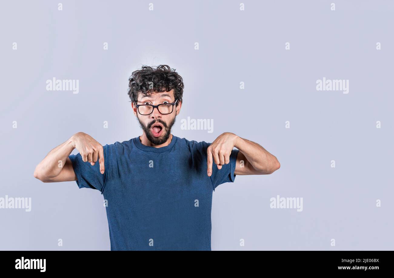Handsome man pointing down, surprised guy pointing his fingers down ... Handsome man pointing down, surprised guy pointing his fingers down ...